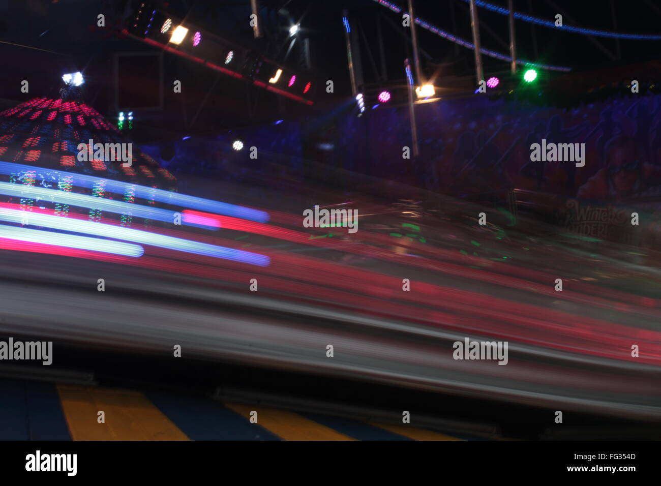 fairground funfair ride moving fast fair lights Night colours of the ...