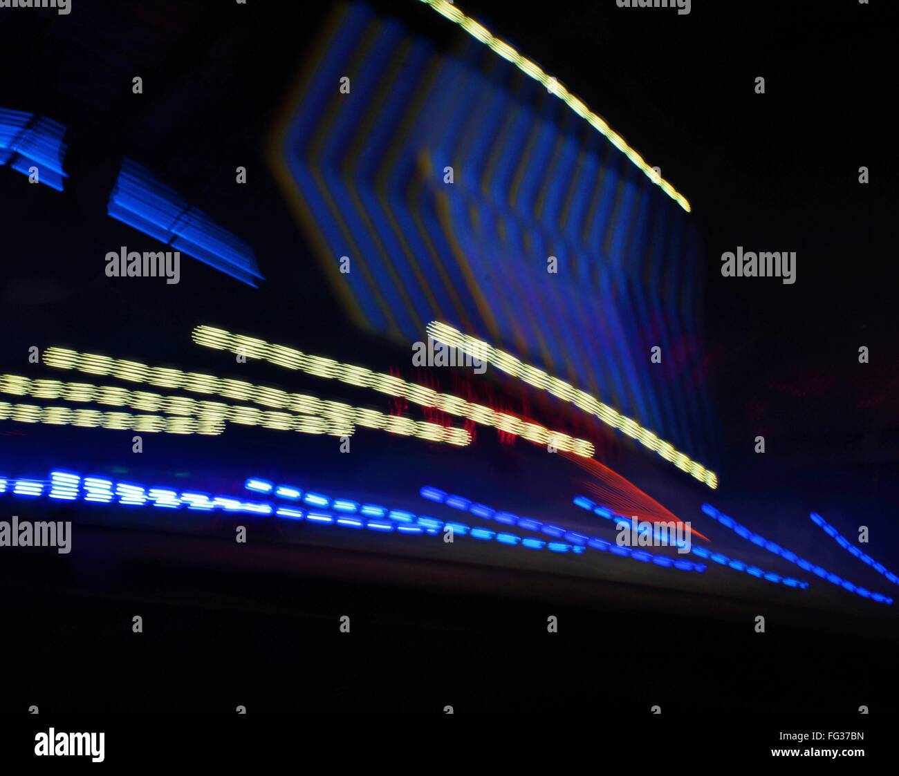 fairground funfair ride moving fast fair lights Night colours of the ...