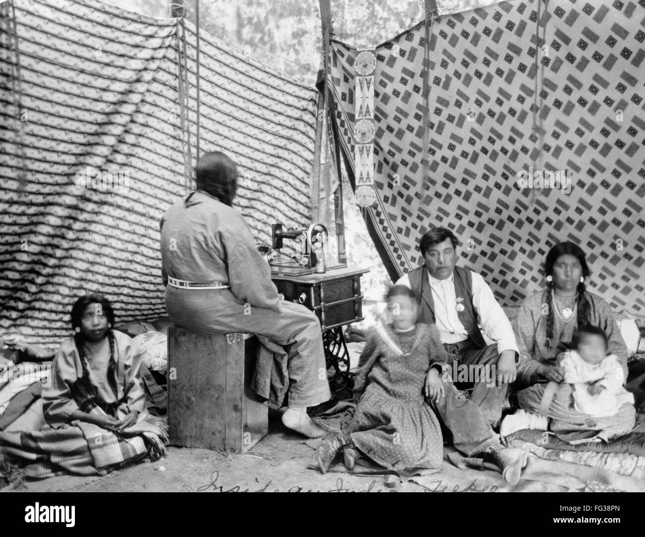 CROW FAMILY, c1906. /nA Crow family inside their tipi. Photograph by T ...
