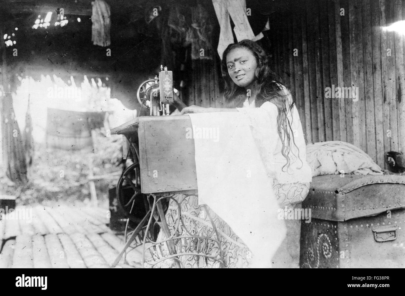 SOUTH AMERICAN INDIAN. /nA South American Indian woman using a sewing ...