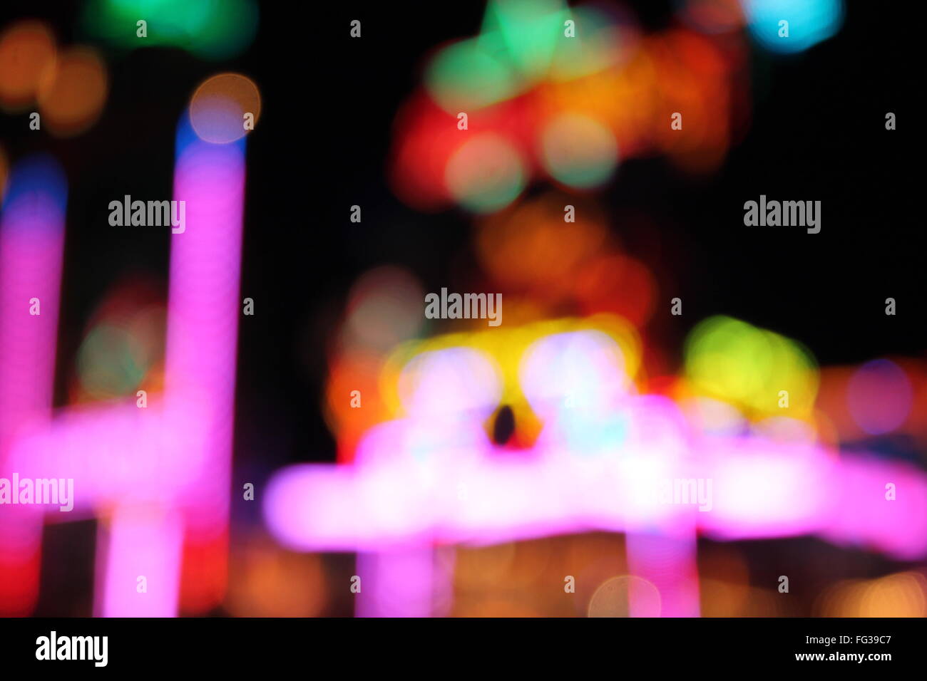 fairground funfair ride moving fast fair lights Night colours of the ...