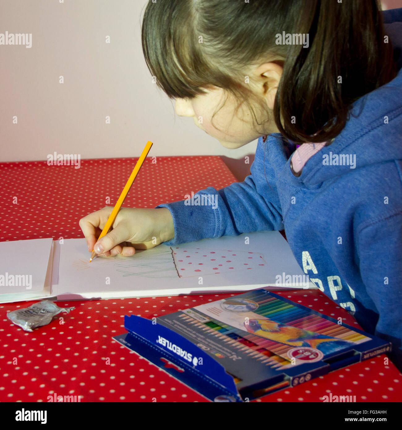 Child using a coloured pencil Stock Photo - Alamy