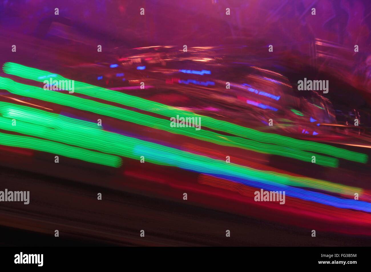 fairground funfair ride moving fast fair lights Night colours of the ...