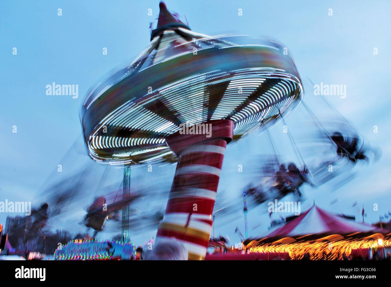 fairground funfair ride moving fast fair lights Night colours of the ...