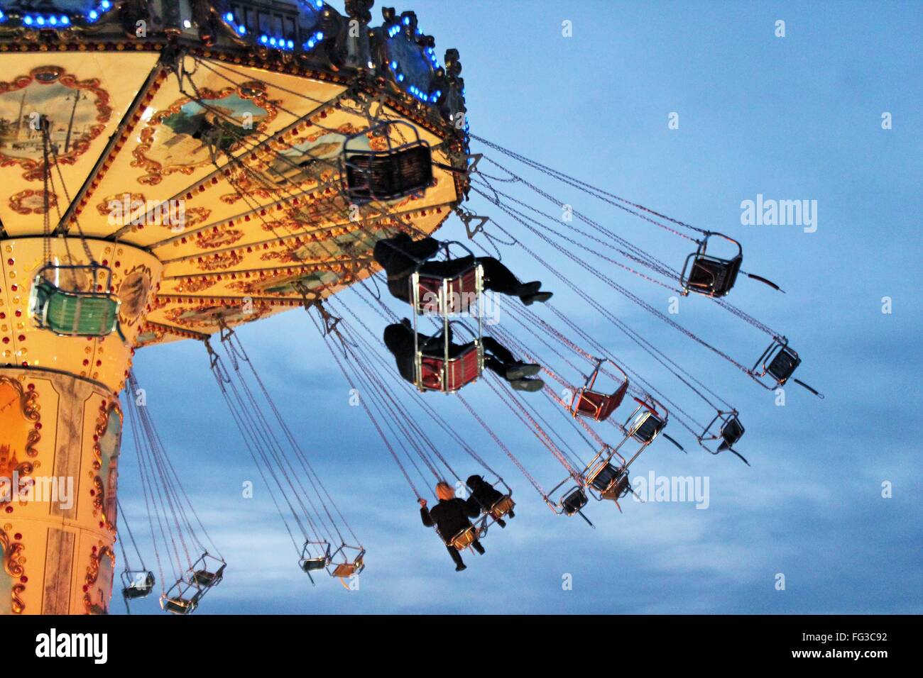 fairground funfair ride moving fast fair lights Night colours of the ...