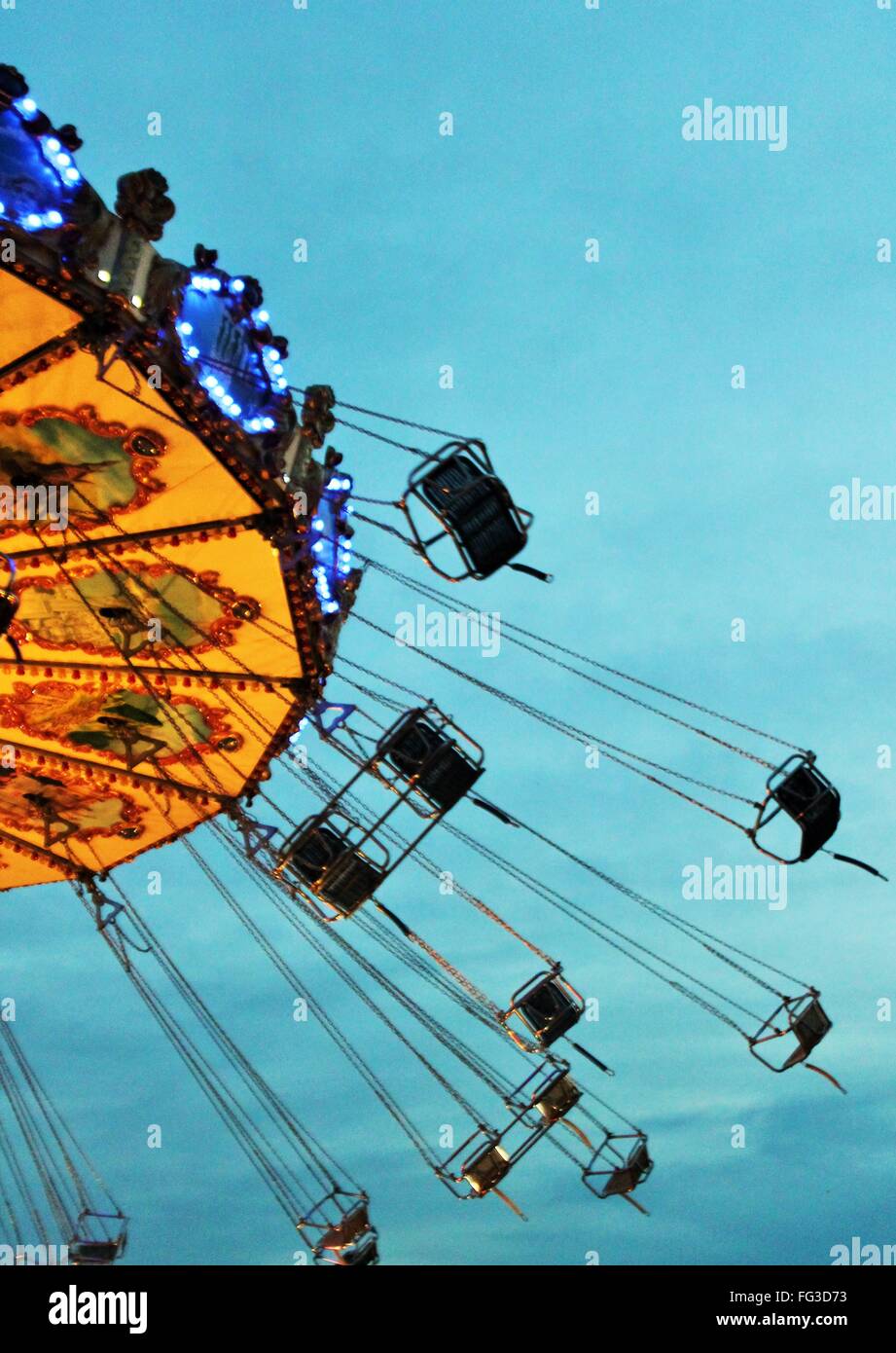 fairground funfair ride moving fast fair lights Night colours of the ...