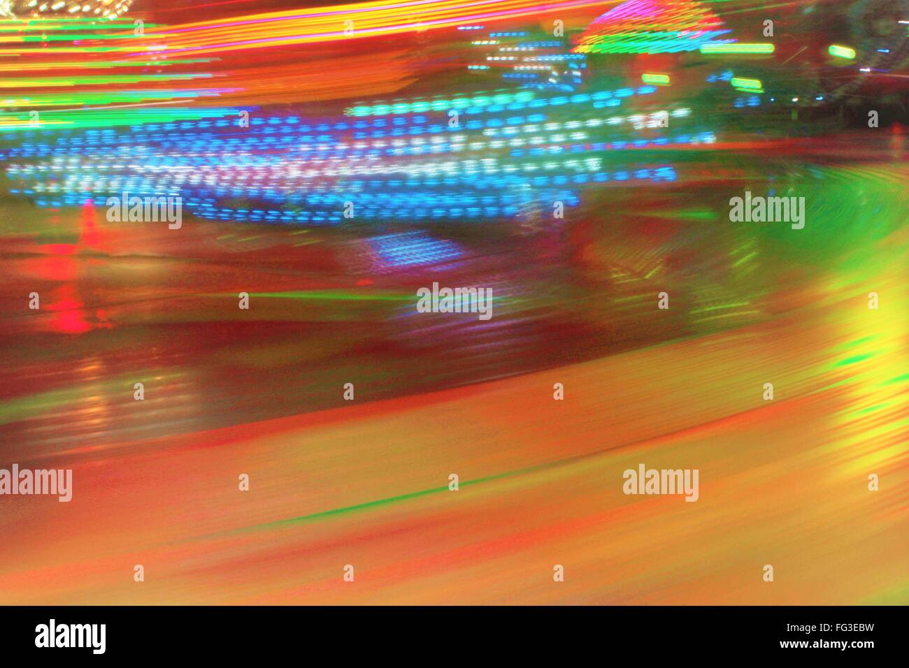 fairground funfair ride moving fast fair lights Night colours of the ...