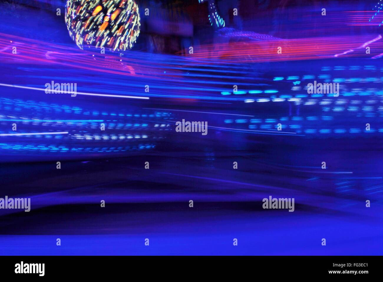 fairground funfair ride moving fast fair lights Night colours amusement ...