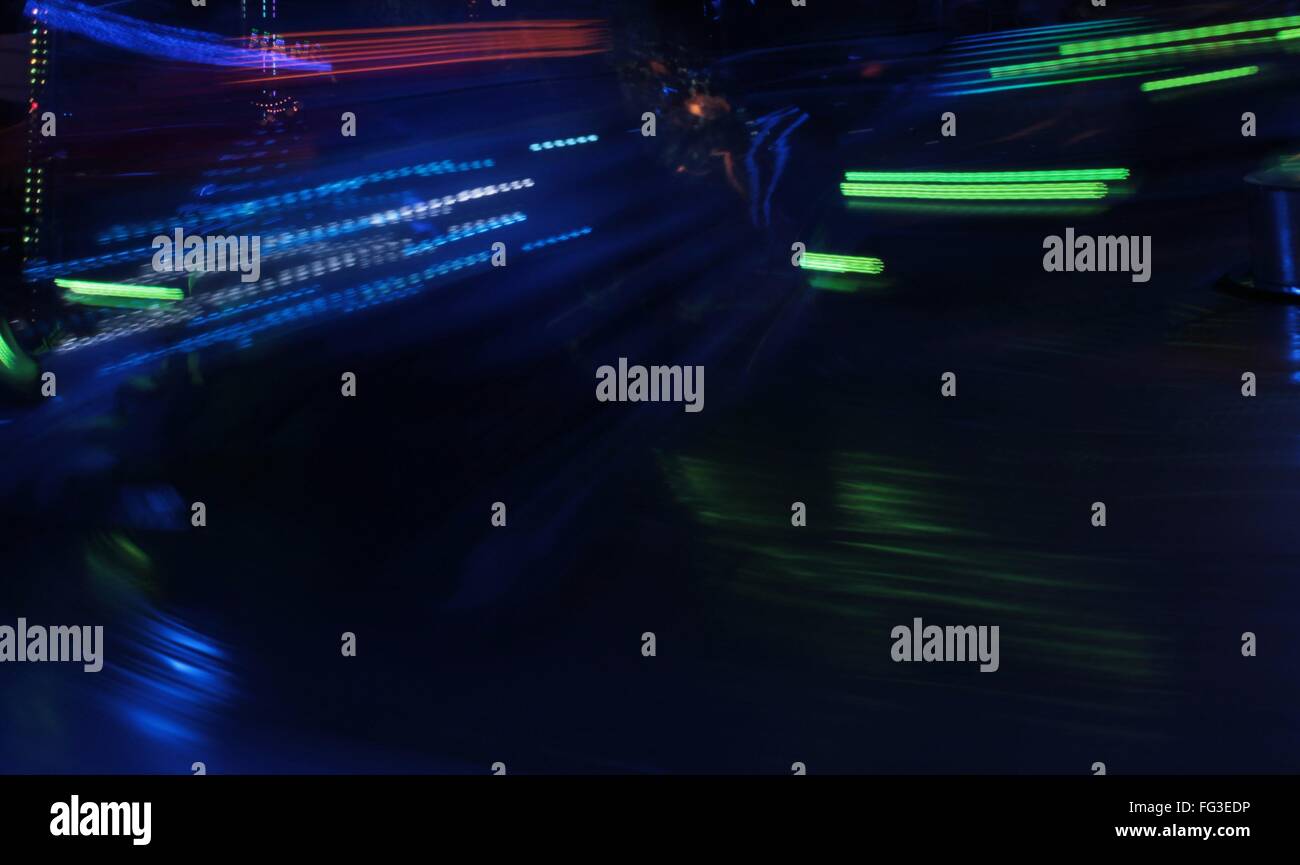 fairground funfair ride moving fast fair lights Night colours of the ...