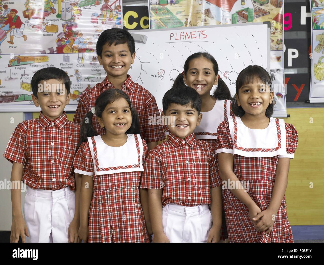 South Asian Indian boys and girls standing together in nursery school ...