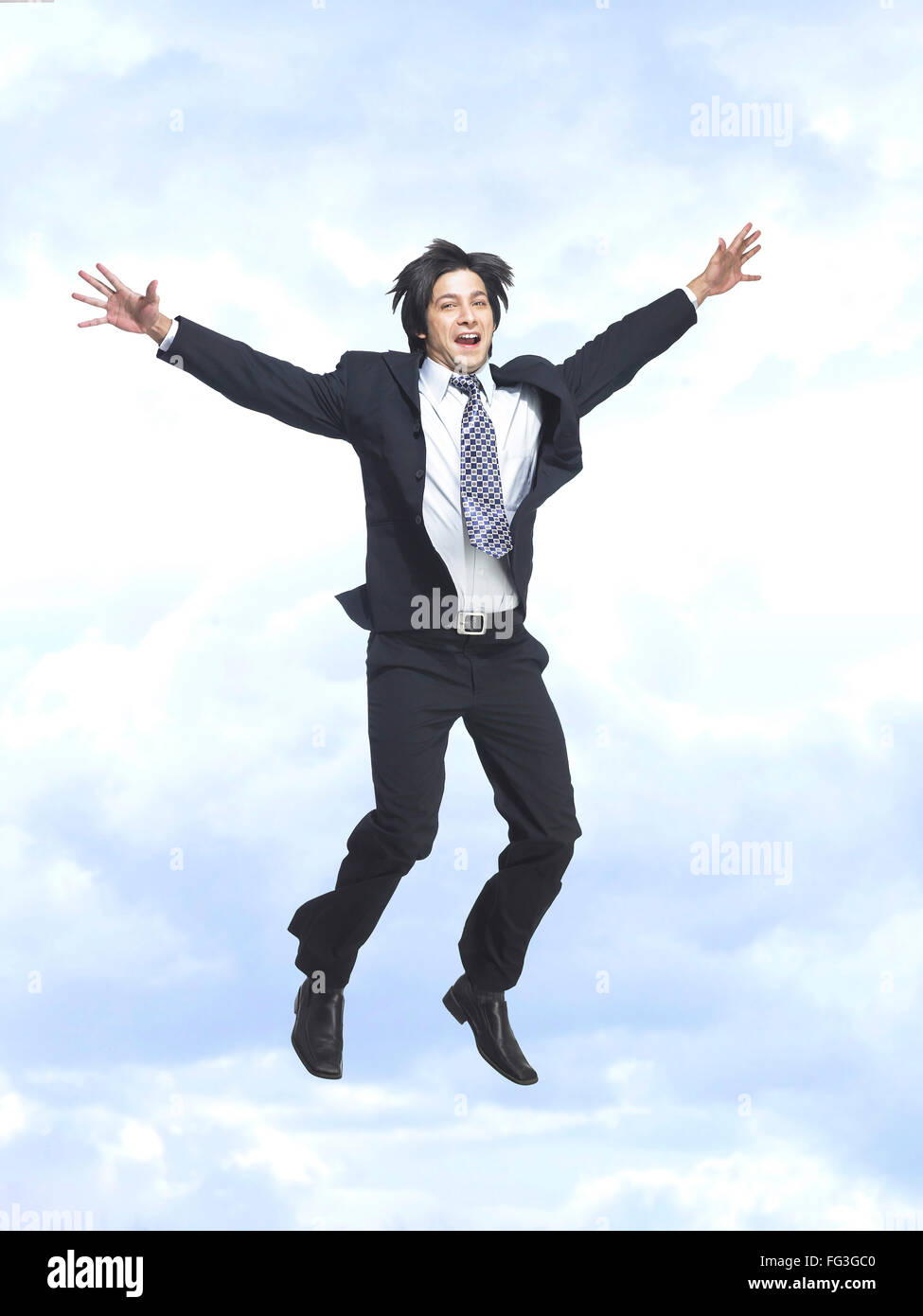 Executive jumping with joy in blue sky MR Stock Photo - Alamy