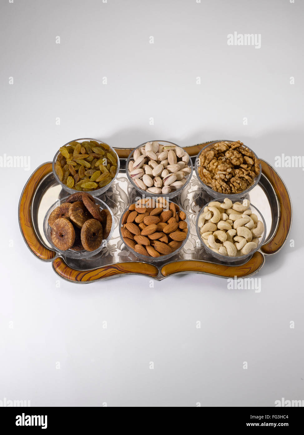 Dry fruits and nuts ; almonds pistachios walnuts raisins figs cashew ...