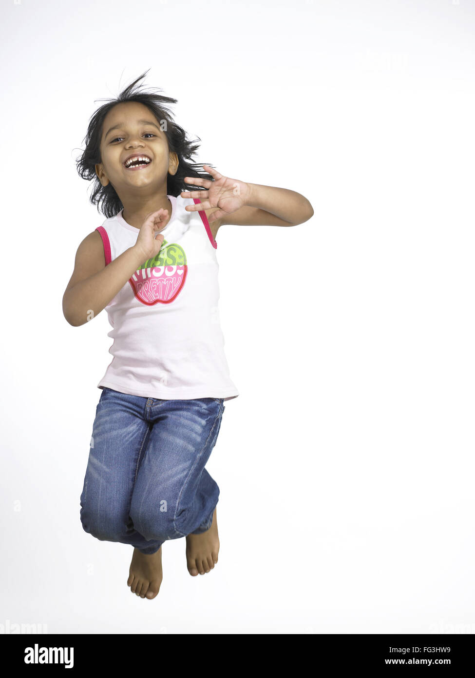 South Asian Indian girl jumping with joy in nursery school MR Stock ...