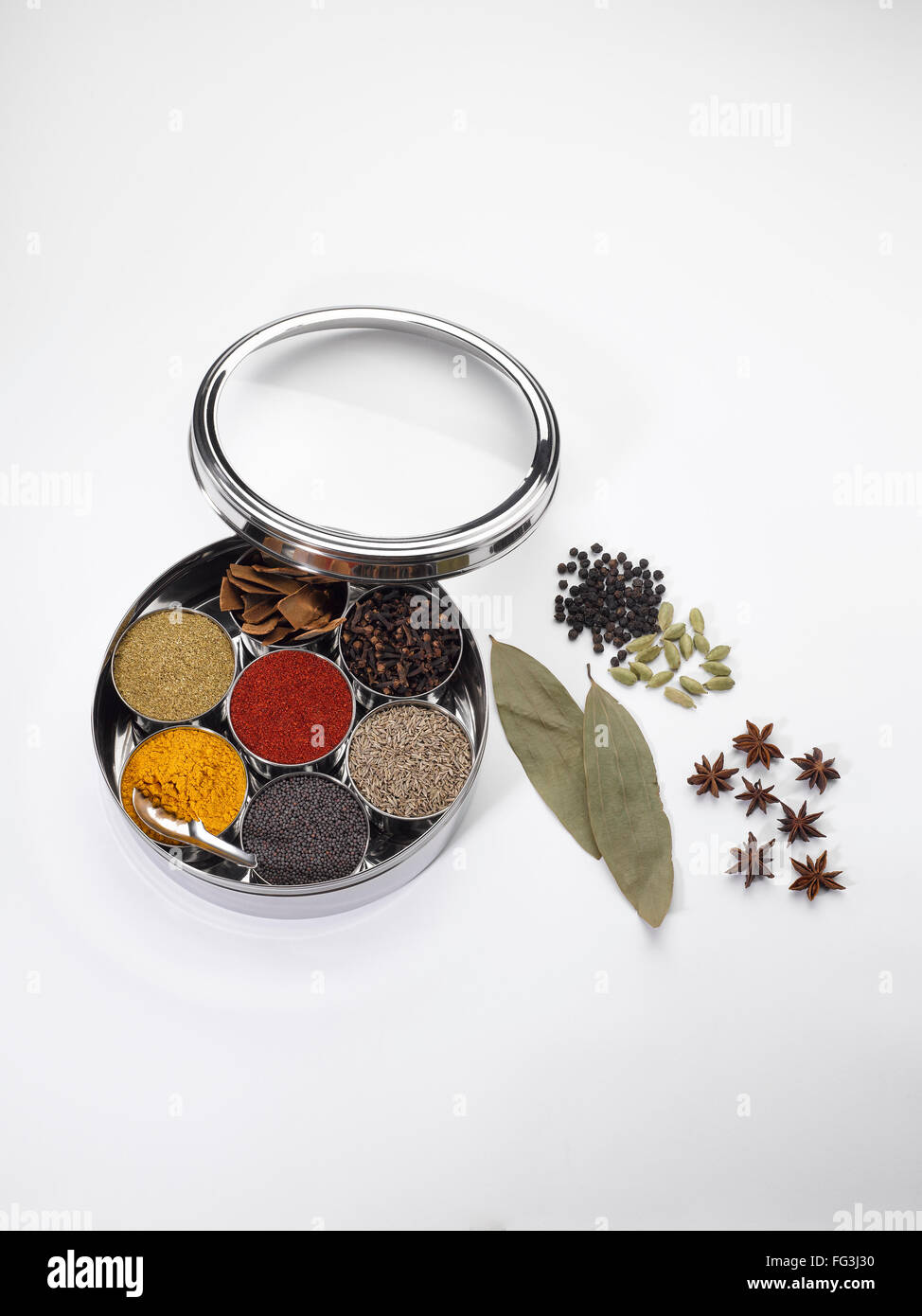 Different types of dry dried spices in bowls in stainless steel box on ...