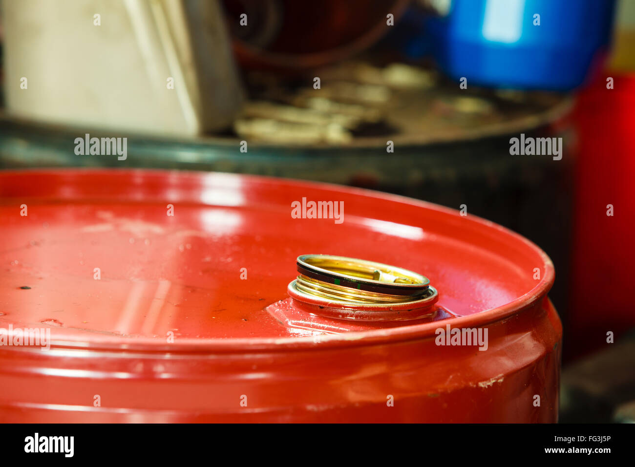 Car servicing oil change. Red oil barrel canister in mechanic garage ...