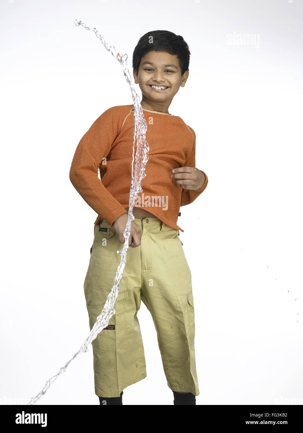 Water splashing on South Asian Indian boy in nursery school MR Stock ...