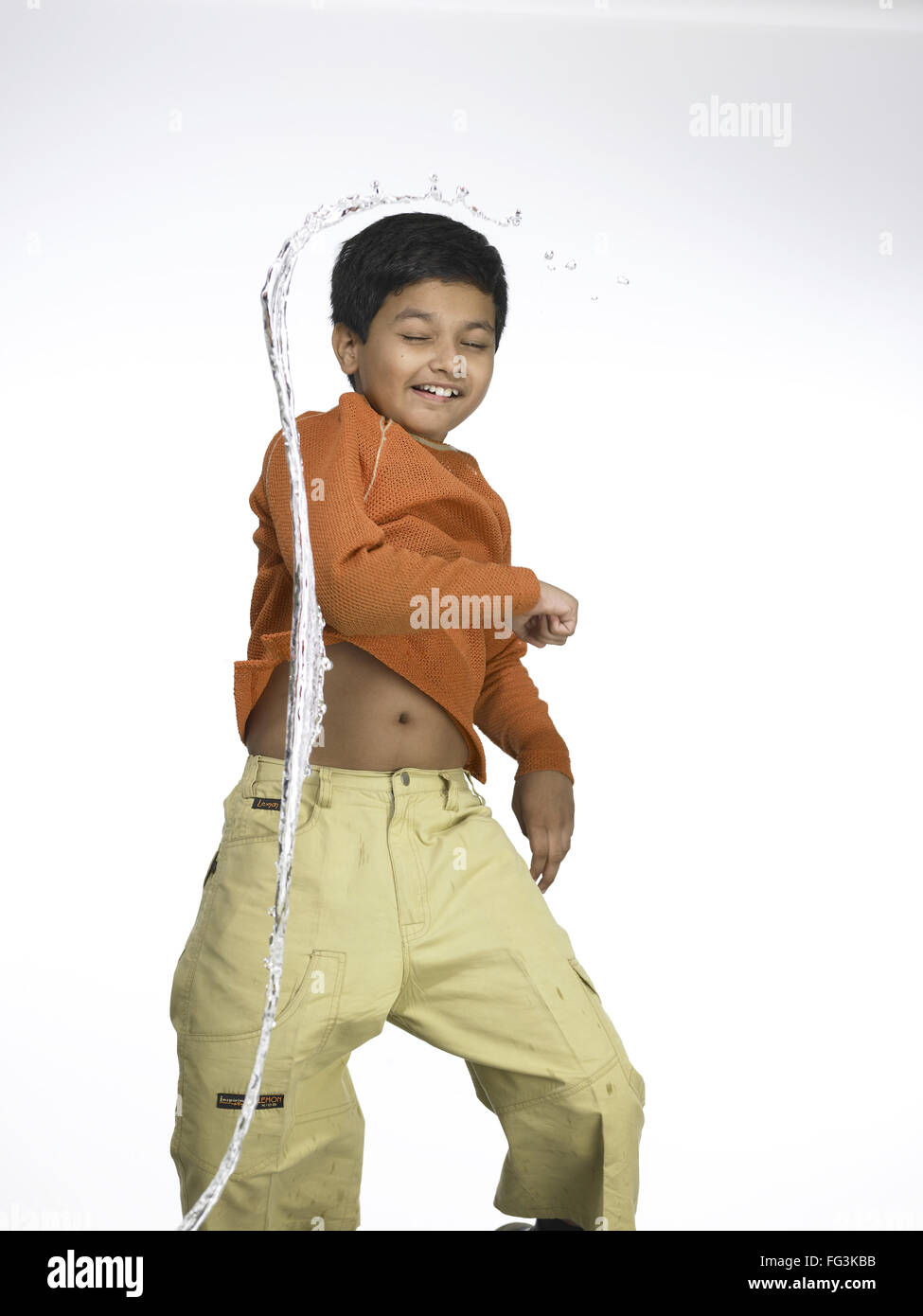 Water splashing on South Asian Indian boy in nursery school MR Stock ...