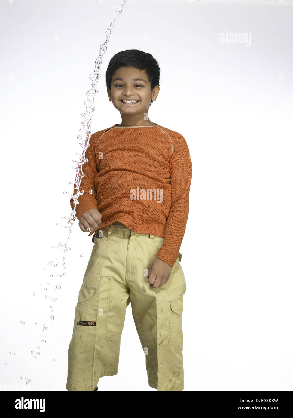 Water splashing on South Asian Indian boy in nursery school MR Stock ...