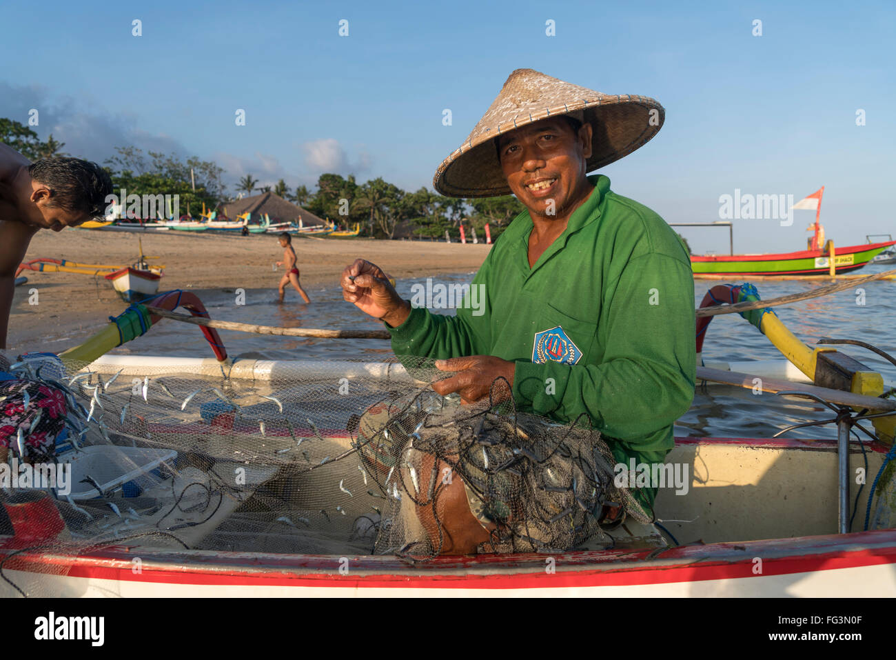 fisherman with boat and net at the beach in Sanur, Bali, Indon Stock ...