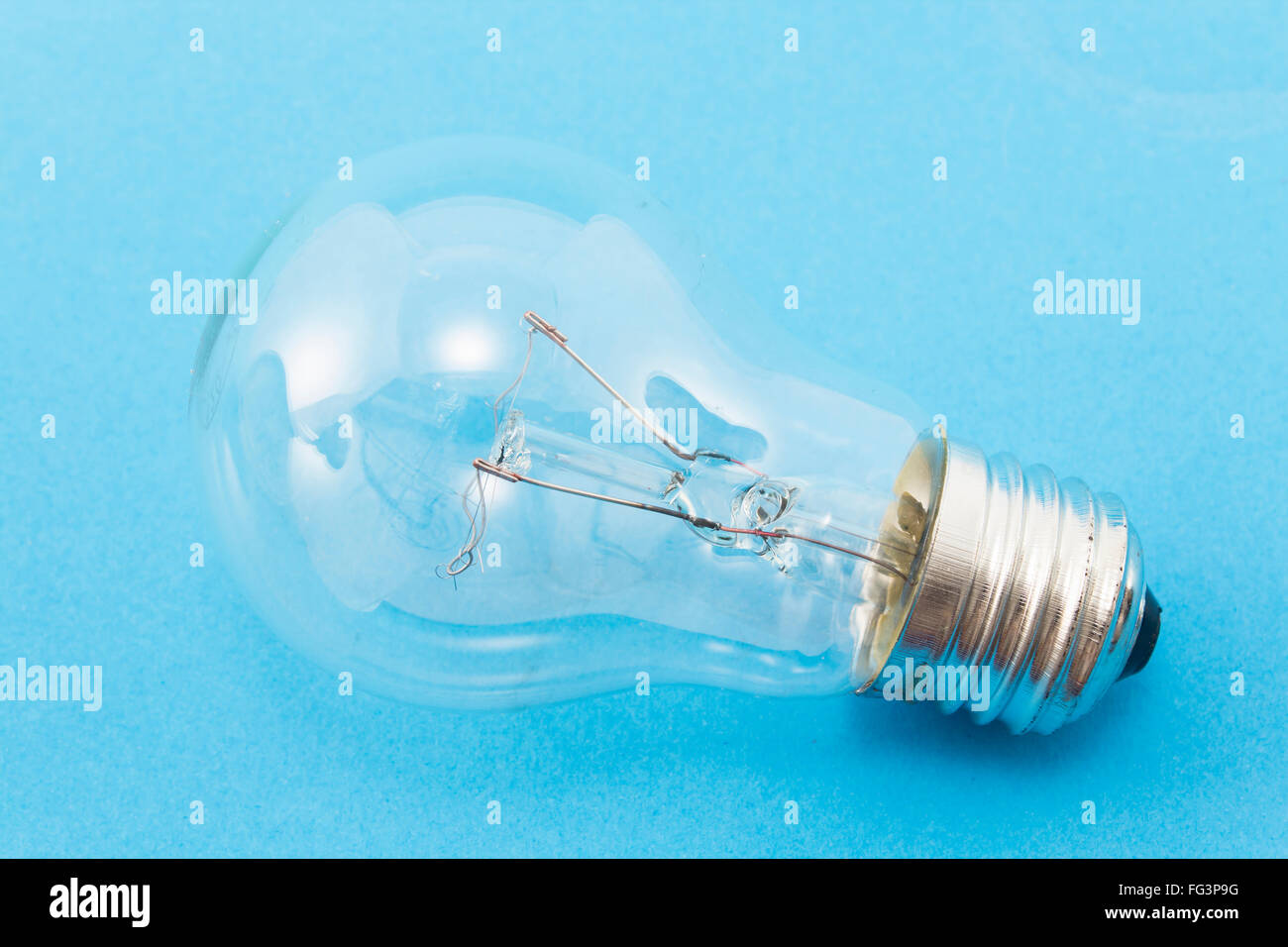 100 W light bulb on a blue background Stock Photo - Alamy