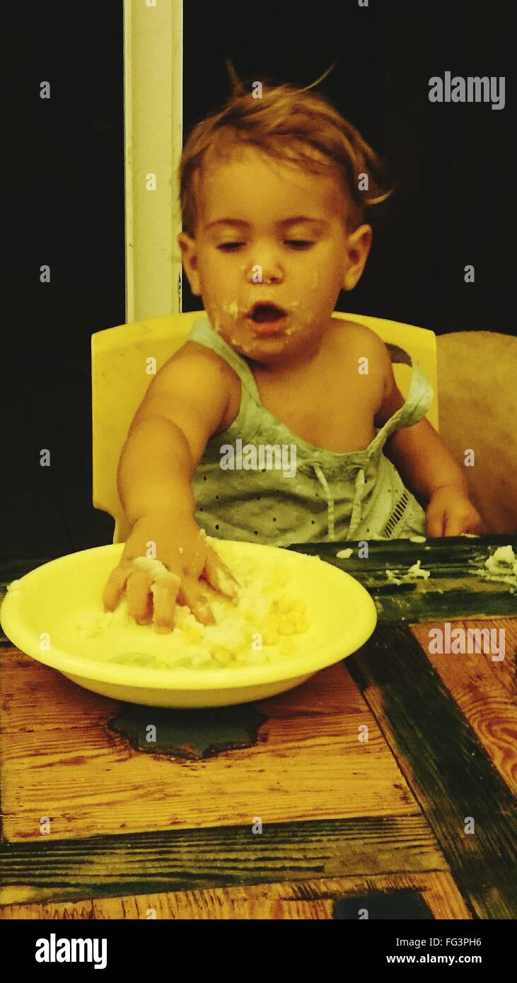 Girl eating with her hand hi-res stock photography and images - Alamy