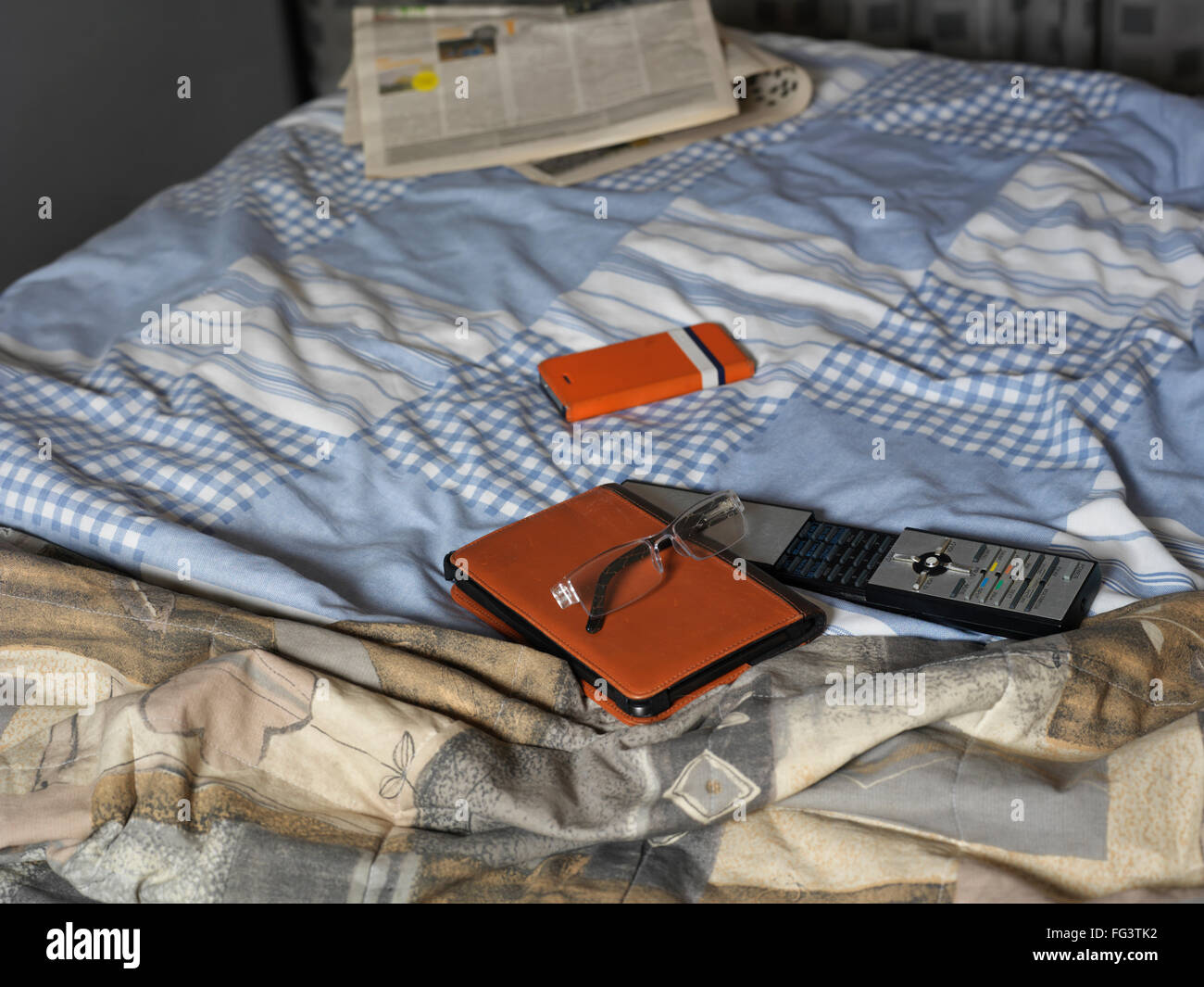 Personal effects on a bed Stock Photo - Alamy