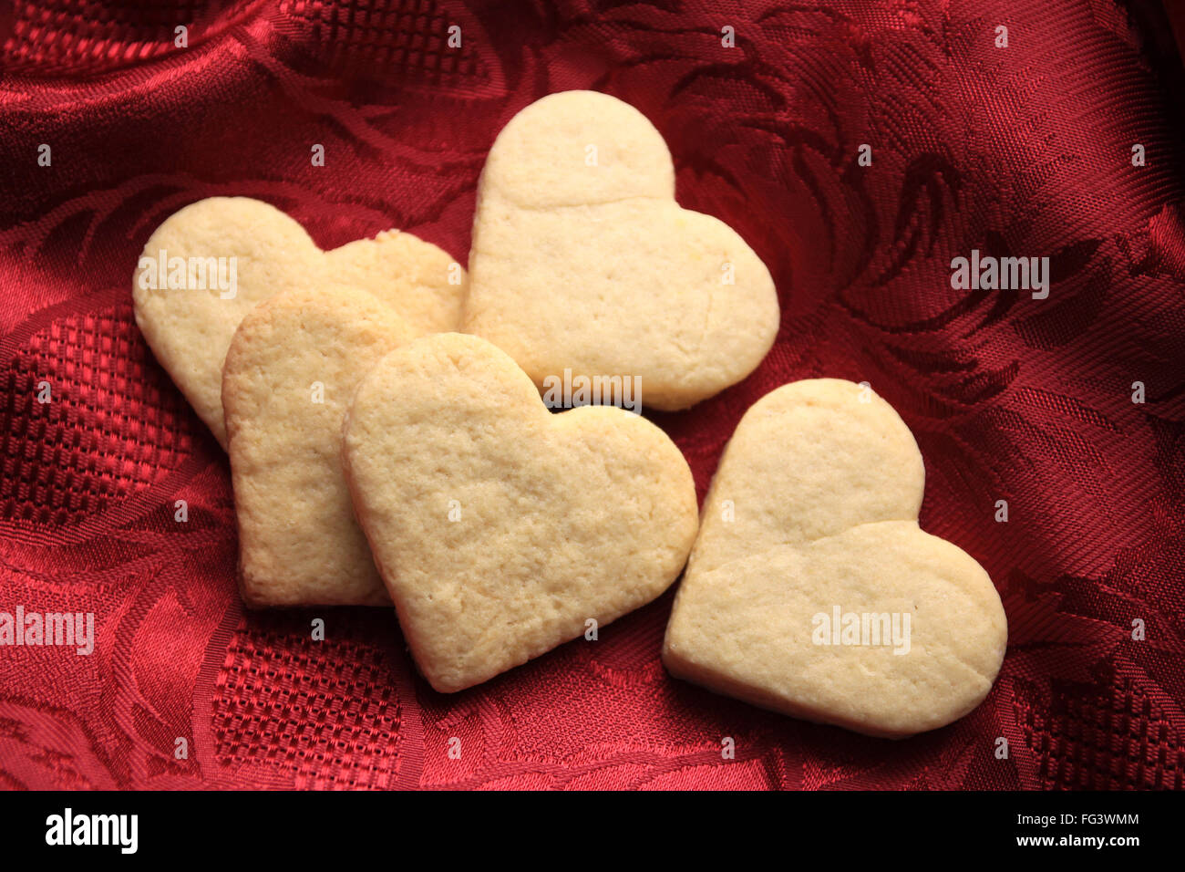 heart shaped shortbread biscuits on a red cloth Stock Photo - Alamy