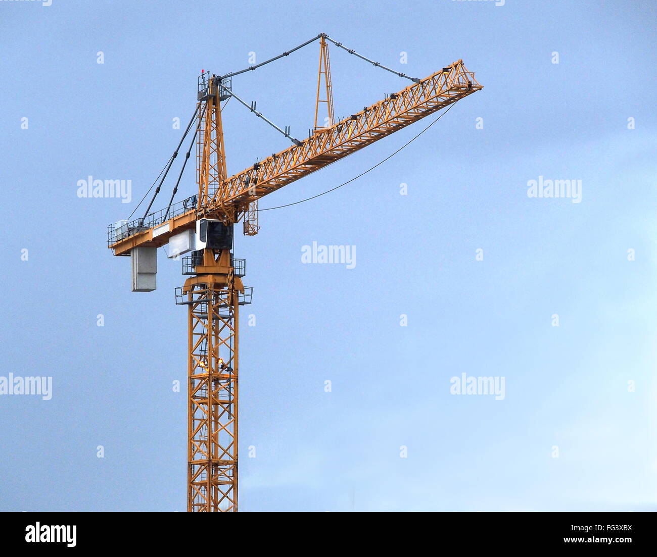 Building crane Yellow building crane with blue sky Stock Photo - Alamy