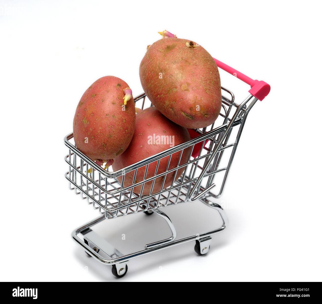 A miniature supermarket shopping trolley with red potatoes inside Stock ...