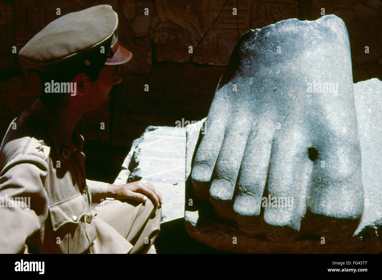 EGYPT: ANCIENT STATUE. /nAn employee standing near the foot of a ...