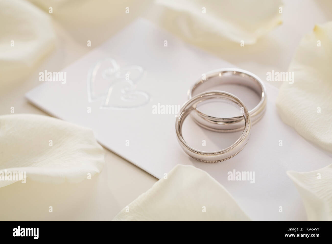 Wedding rings on wedding invitation Stock Photo - Alamy