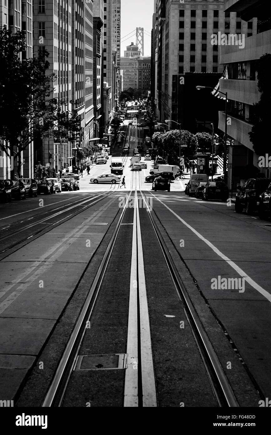 Railroad Tracks On City Street By Buildings Stock Photo - Alamy