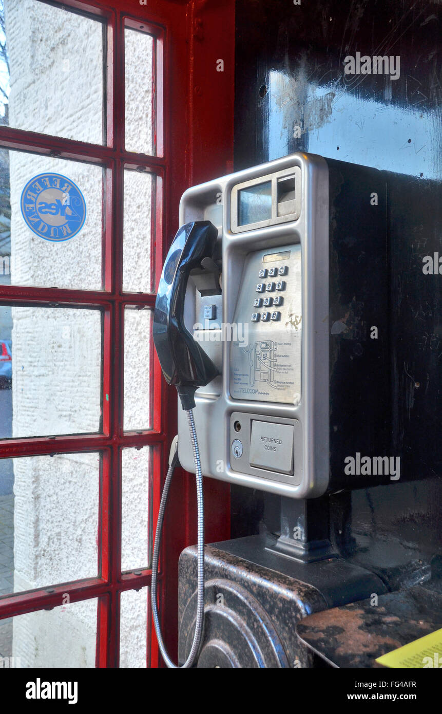 A red UK phone box with a money / coin paying landline telephone Stock ...