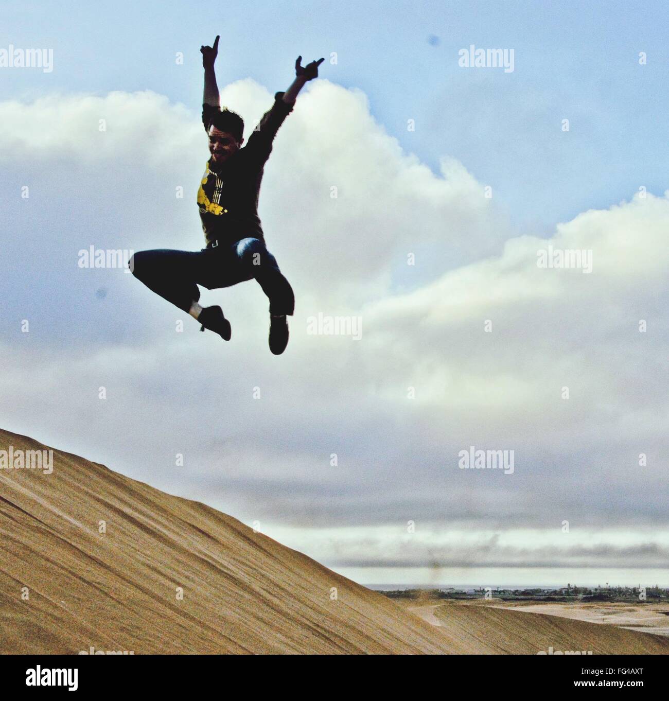 Man Jumping Mid-Air On Beach Stock Photo - Alamy