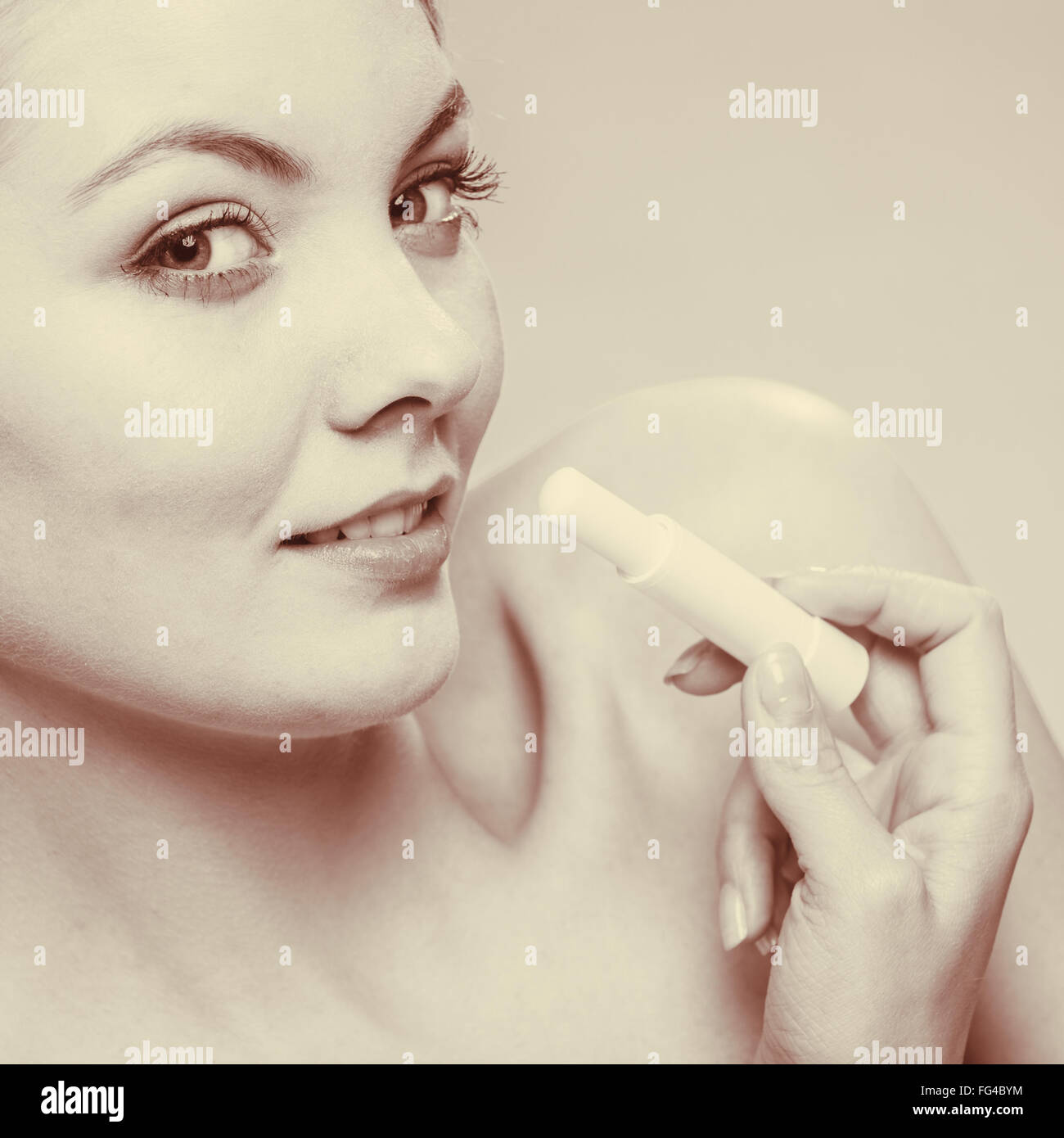 Female put on skin moisturizing balsam. Keep smoothing lipcare Stock ...