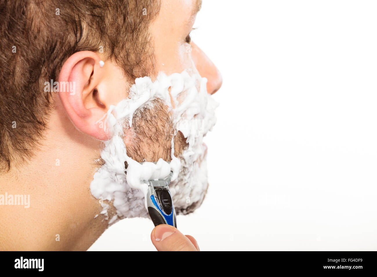 Man shaving using razor with cream foam. Guy removing face beard hair. Skin care and hygiene ...