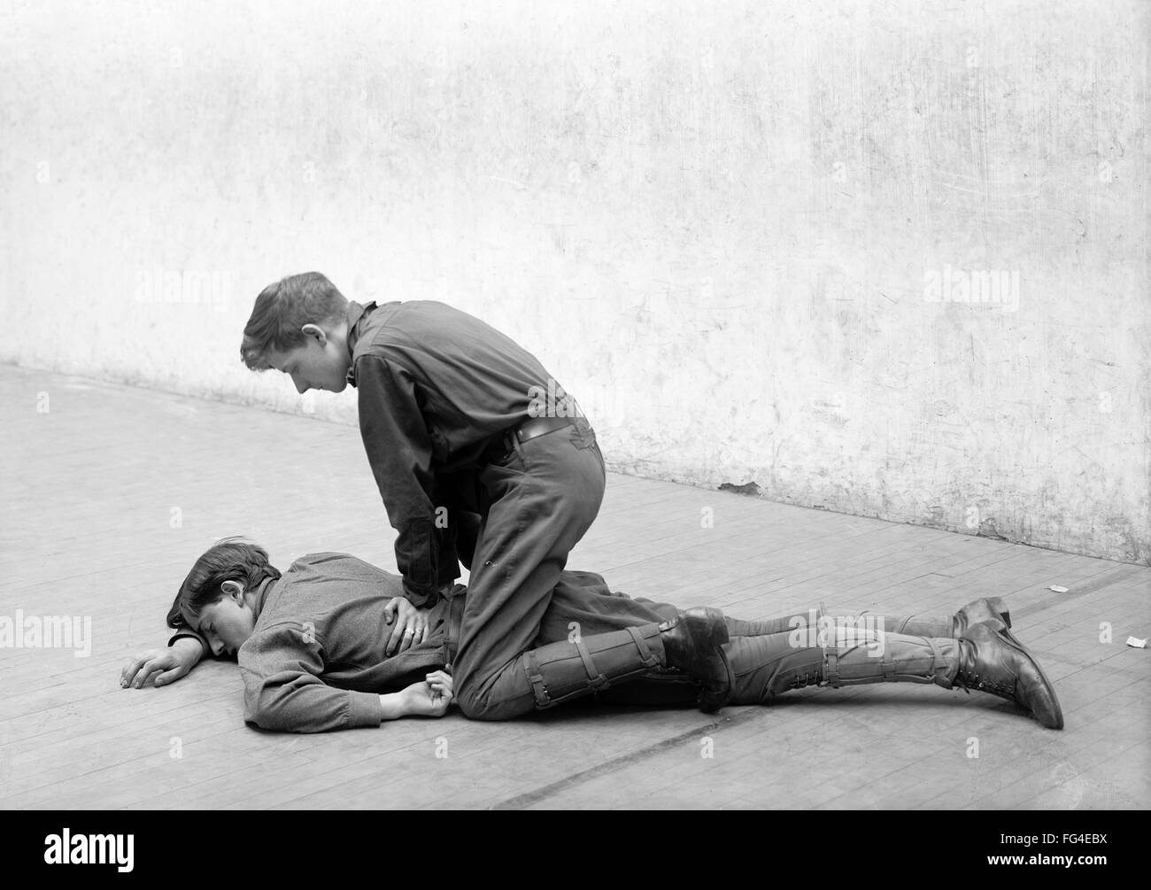 BOY SCOUTS, 1912. /nTwo Boy Scouts demonstrating first aid techniques ...