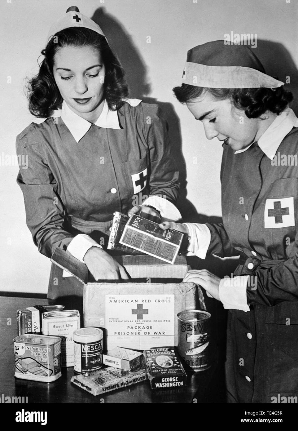 WWII: RED CROSS, 1942. /nRed Cross nurses creating packages of food ...