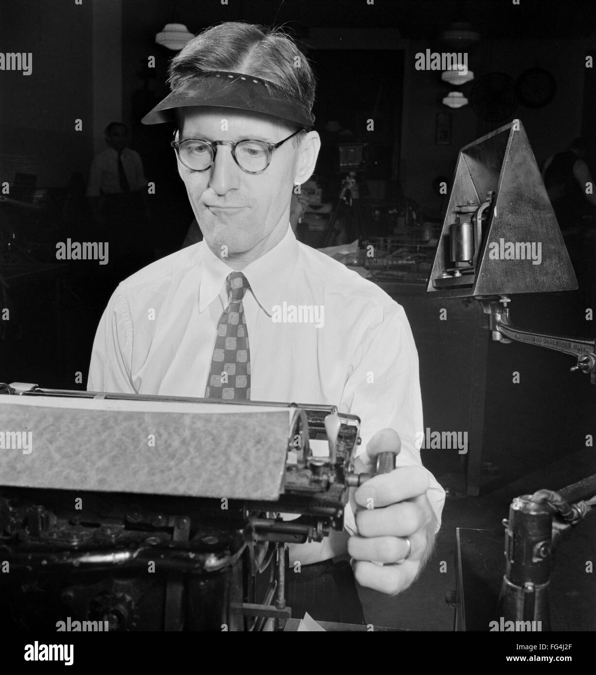 NEW YORK TIMES OFFICE, 1942. /nA telegraph operator on the direct wire ...