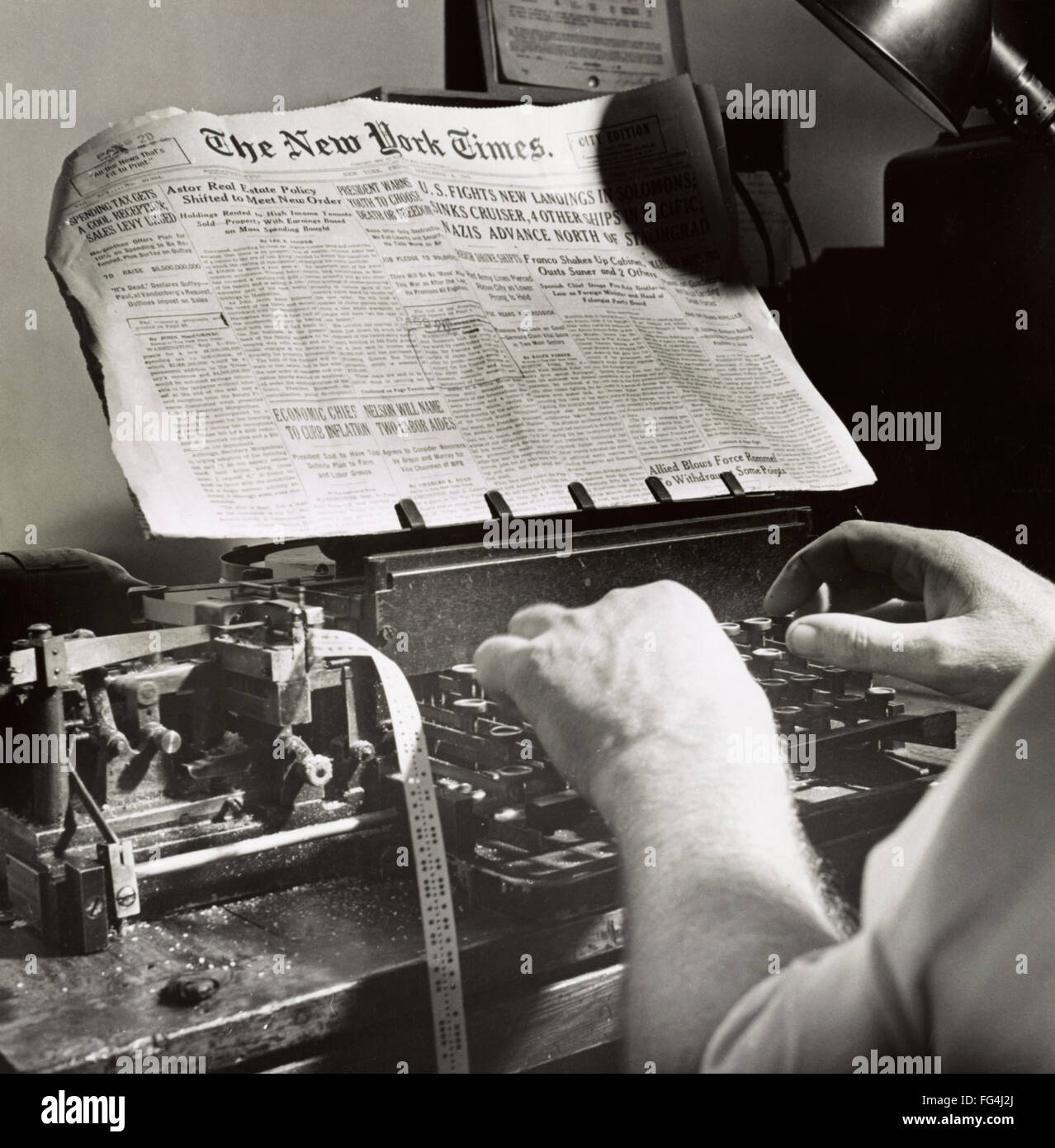 NEW YORK TIMES OFFICE, 1942. /nA copy reader at the telegraph desk in ...