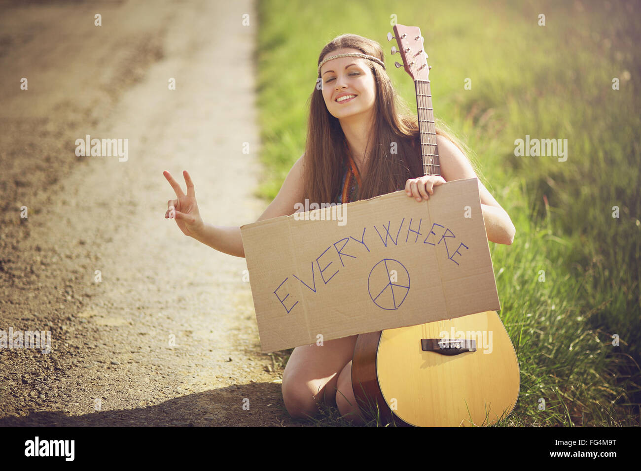 Beautiful hippie woman on a country road . Freedom and journey concept ...