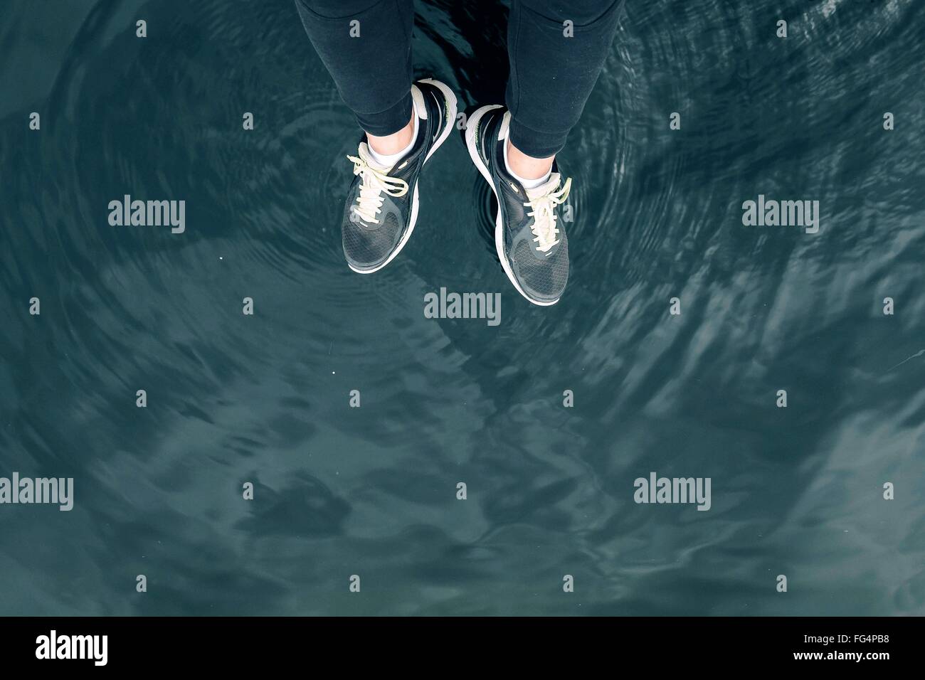 Woman dangling her legs over the water hi-res stock photography and ...