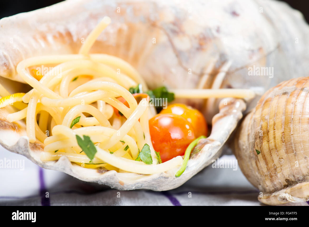 Italian spaghetti and clams in a large shell Stock Photo - Alamy