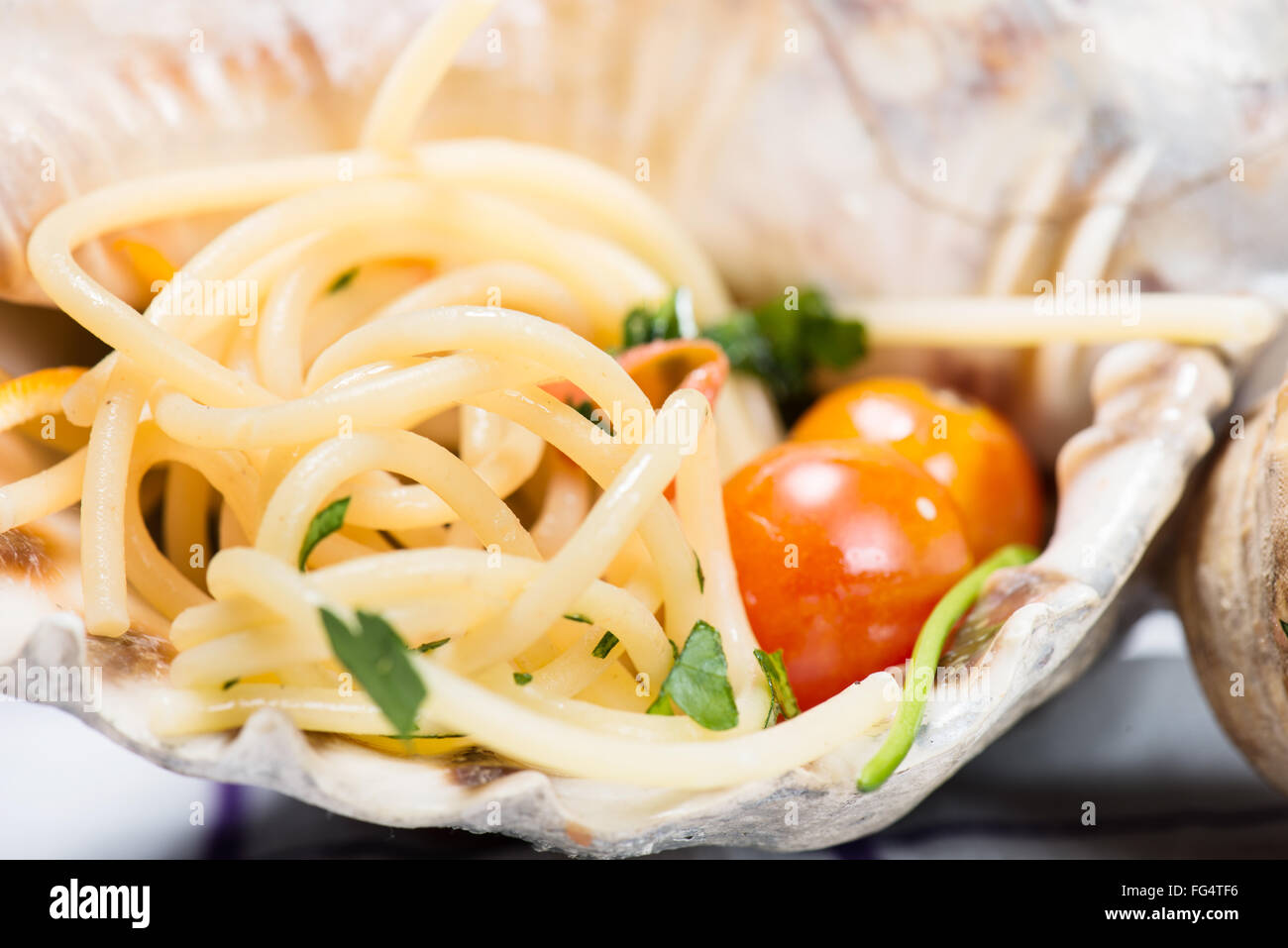 Italian spaghetti and clams in a large shell Stock Photo - Alamy