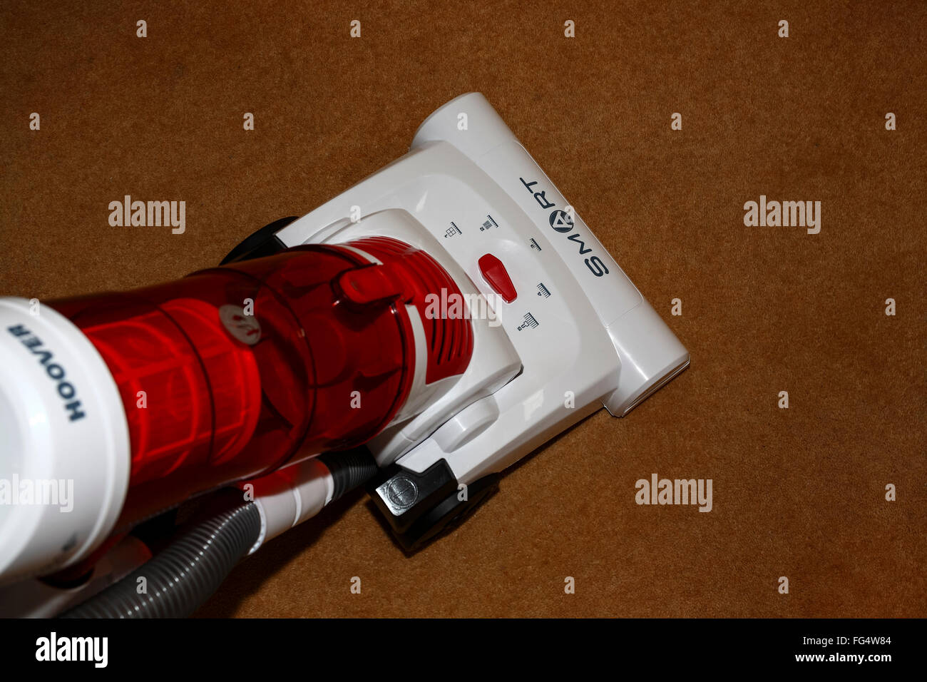 Using a Hoover smart vacuum cleaner to clean a carpet Stock Photo - Alamy