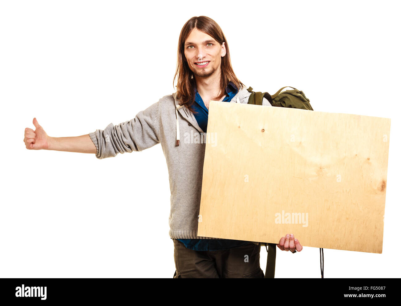 Man tourist backpacker holding blank wood plank copy space. Young guy ...