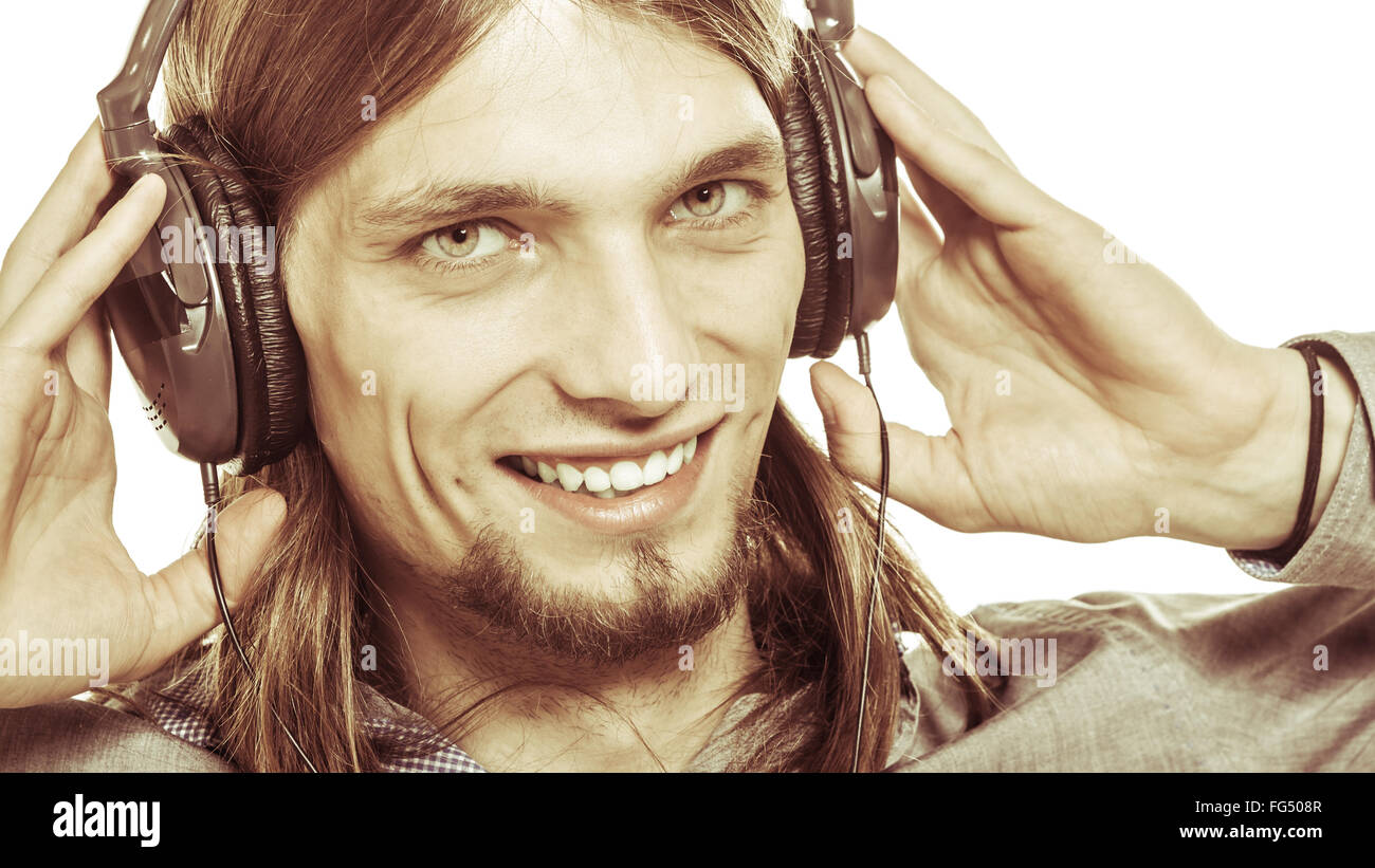 Young man with headphones listening to music. Guy relaxing enjoying ...