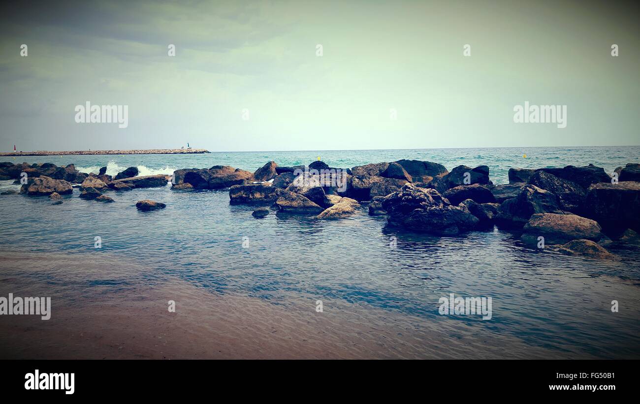 Water over rocks at beach hi-res stock photography and images - Alamy
