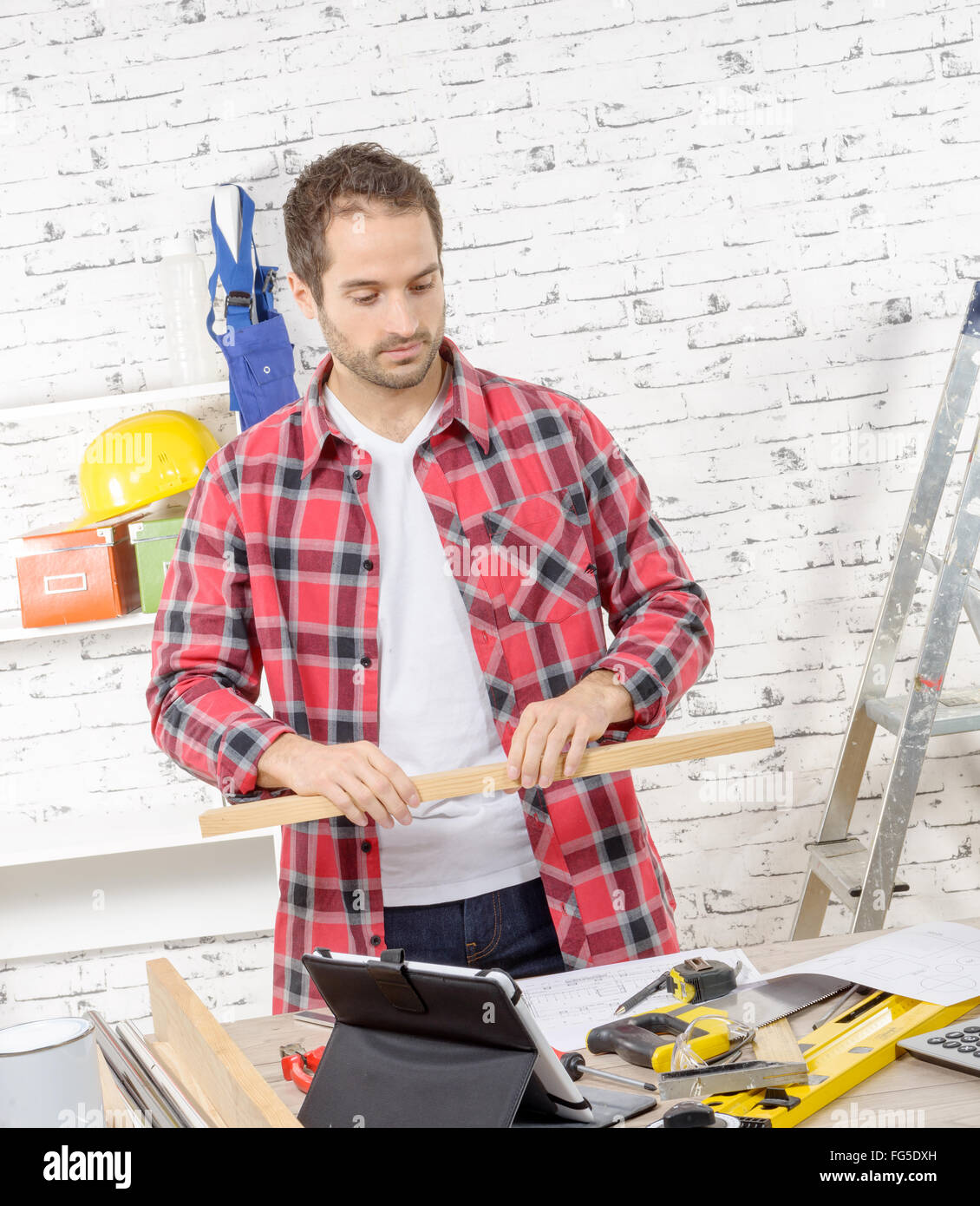 a young worker with a wooden board Stock Photo - Alamy