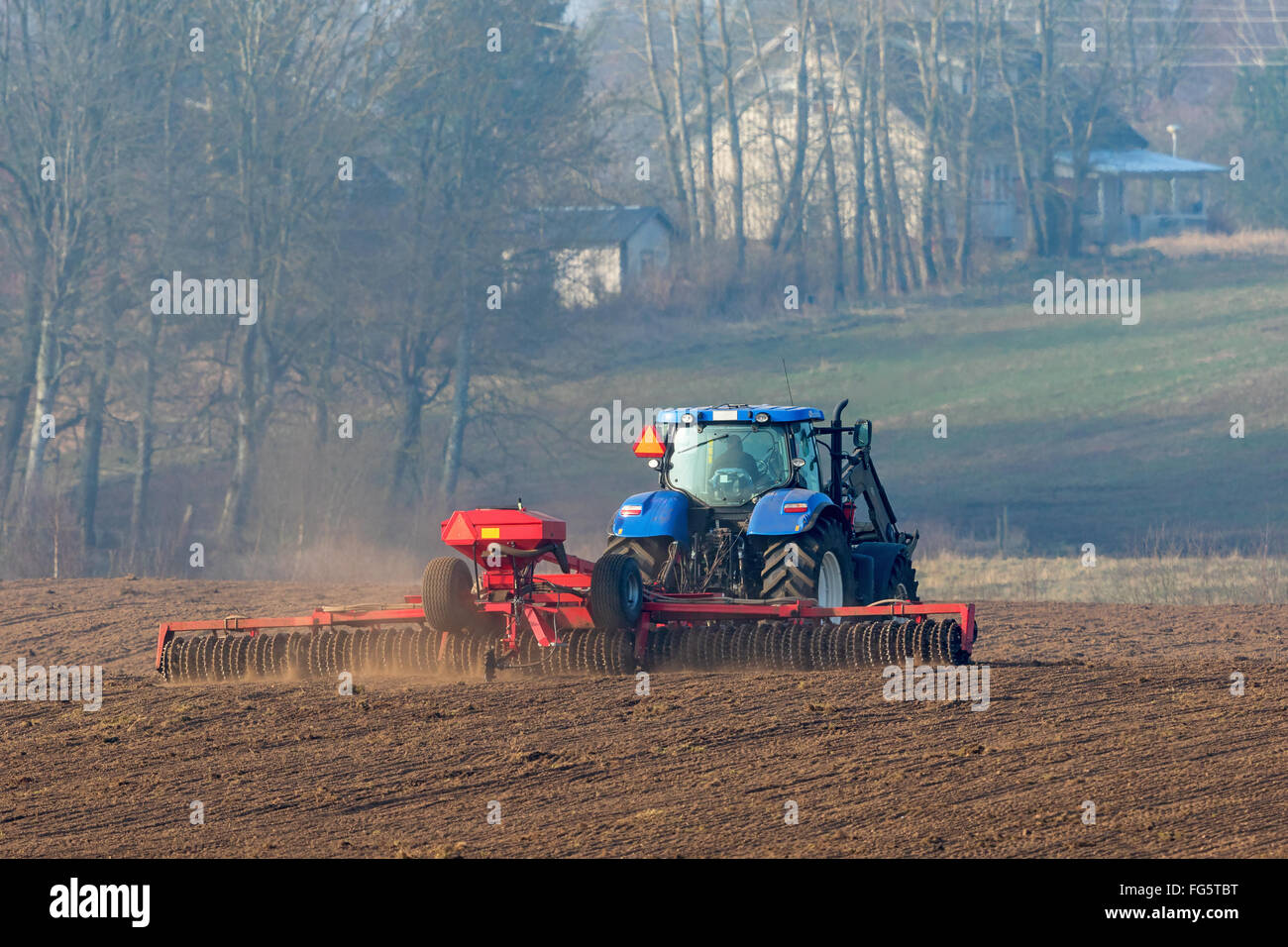 Tractor with a cultipacker rollers on the field at spring Stock Photo ...
